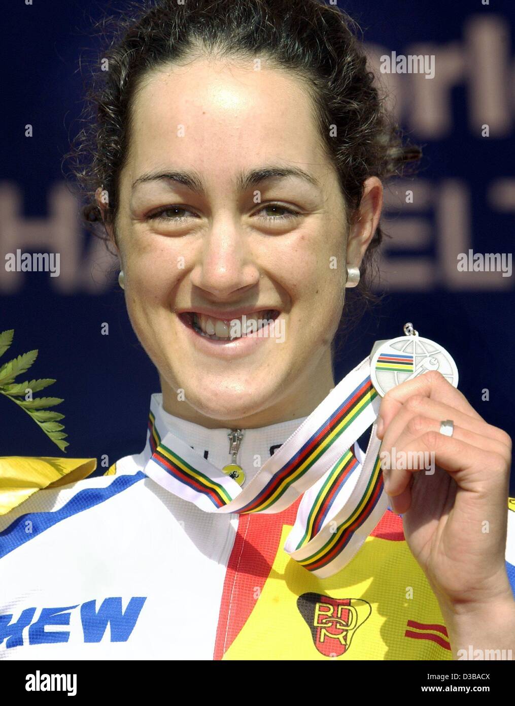 (dpa) - German cyclist Claudia Stumpf shows off her silver medal after ...