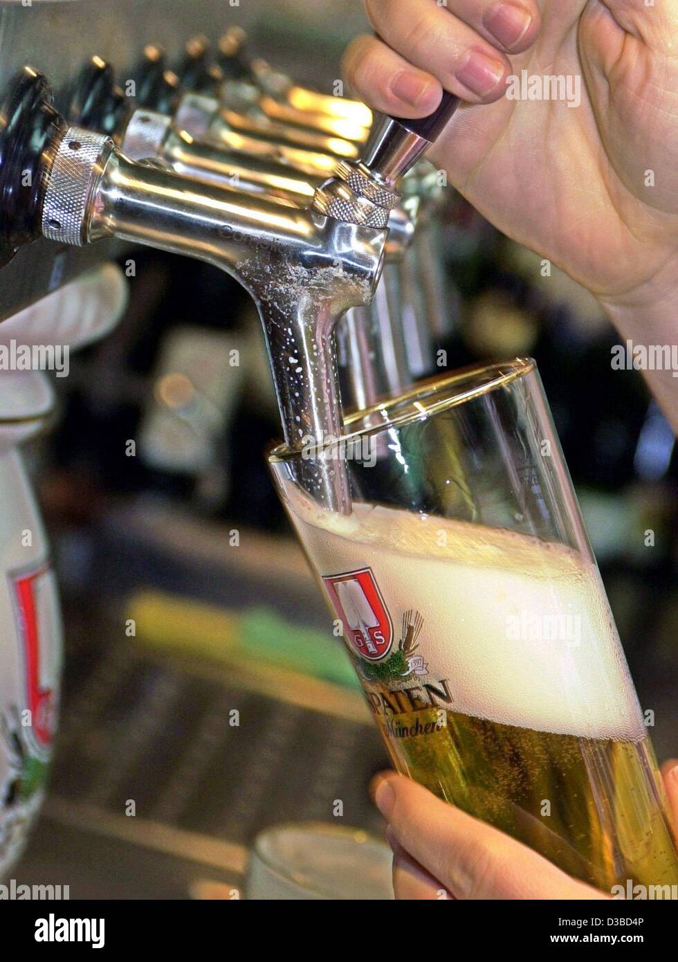 (dpa) - A hand pulls the tap and pours beer into a glass in a pub in ...
