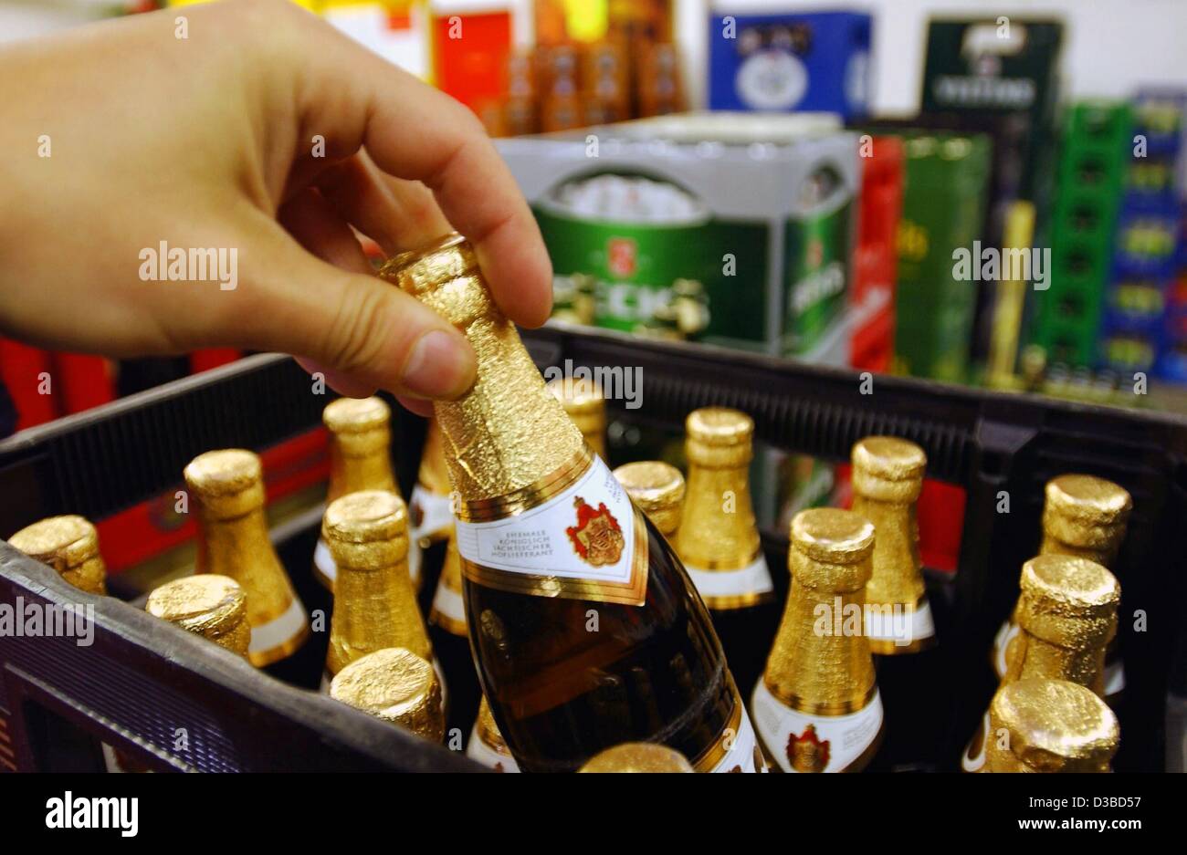 (dpa) - A customer takes a bottle of beer from a beer crate in a ...