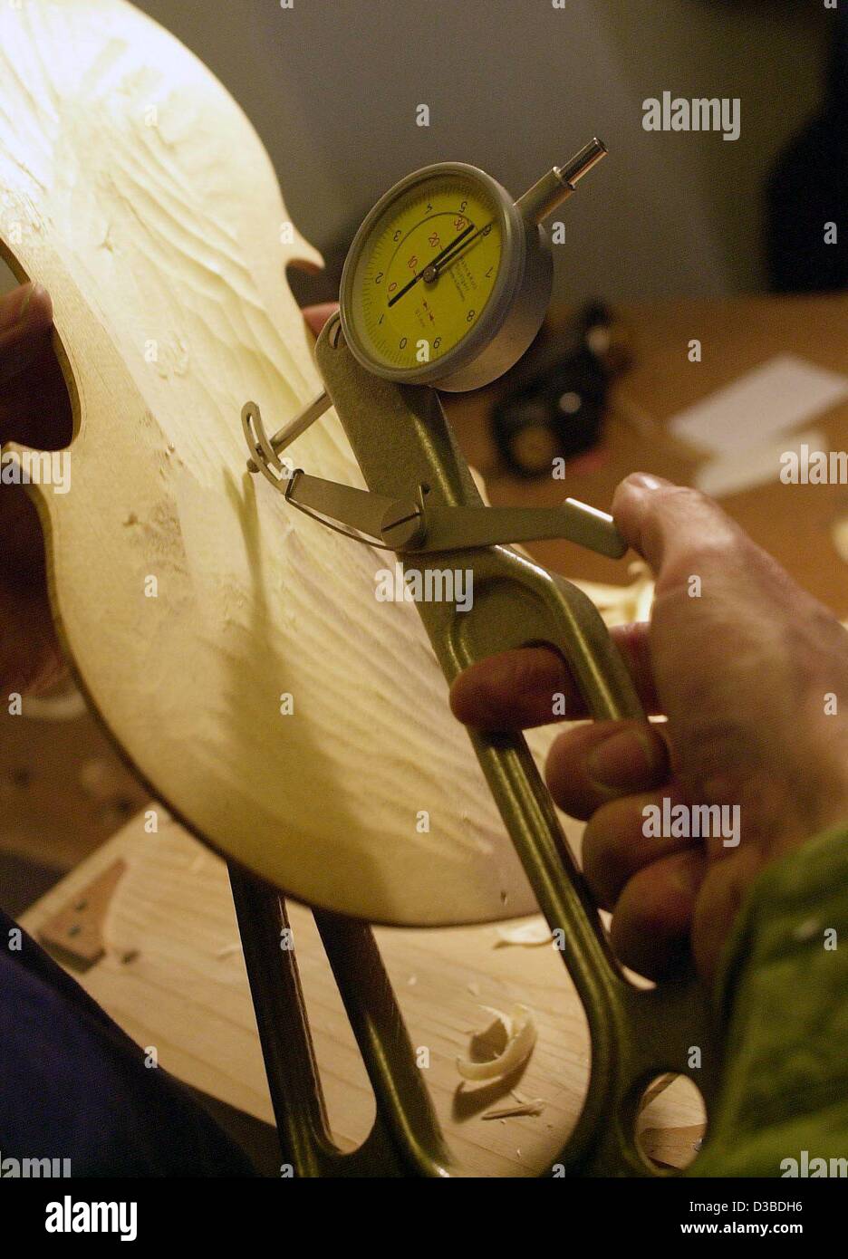 (dpa) - Violin maker Andreas Hampel meticulously crafts a viola with a ...