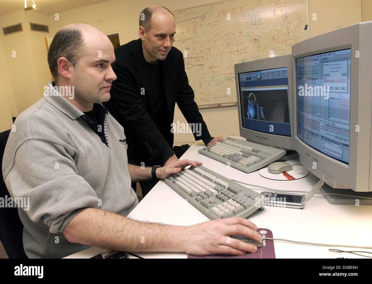 (dpa) - Software designers Thomas Driemeyer (front, L) and Rolf Herken ...