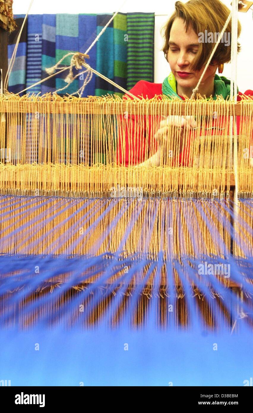 (dpa) - Weaver and fabric designer Ulrike Isensee works diligently at ...