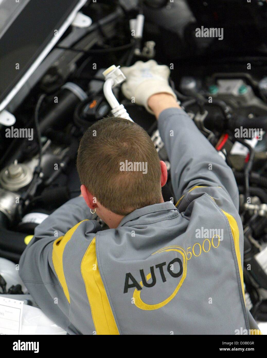 (dpa) - The logo 'Auto 5000' is seen on the back of a worker who ...