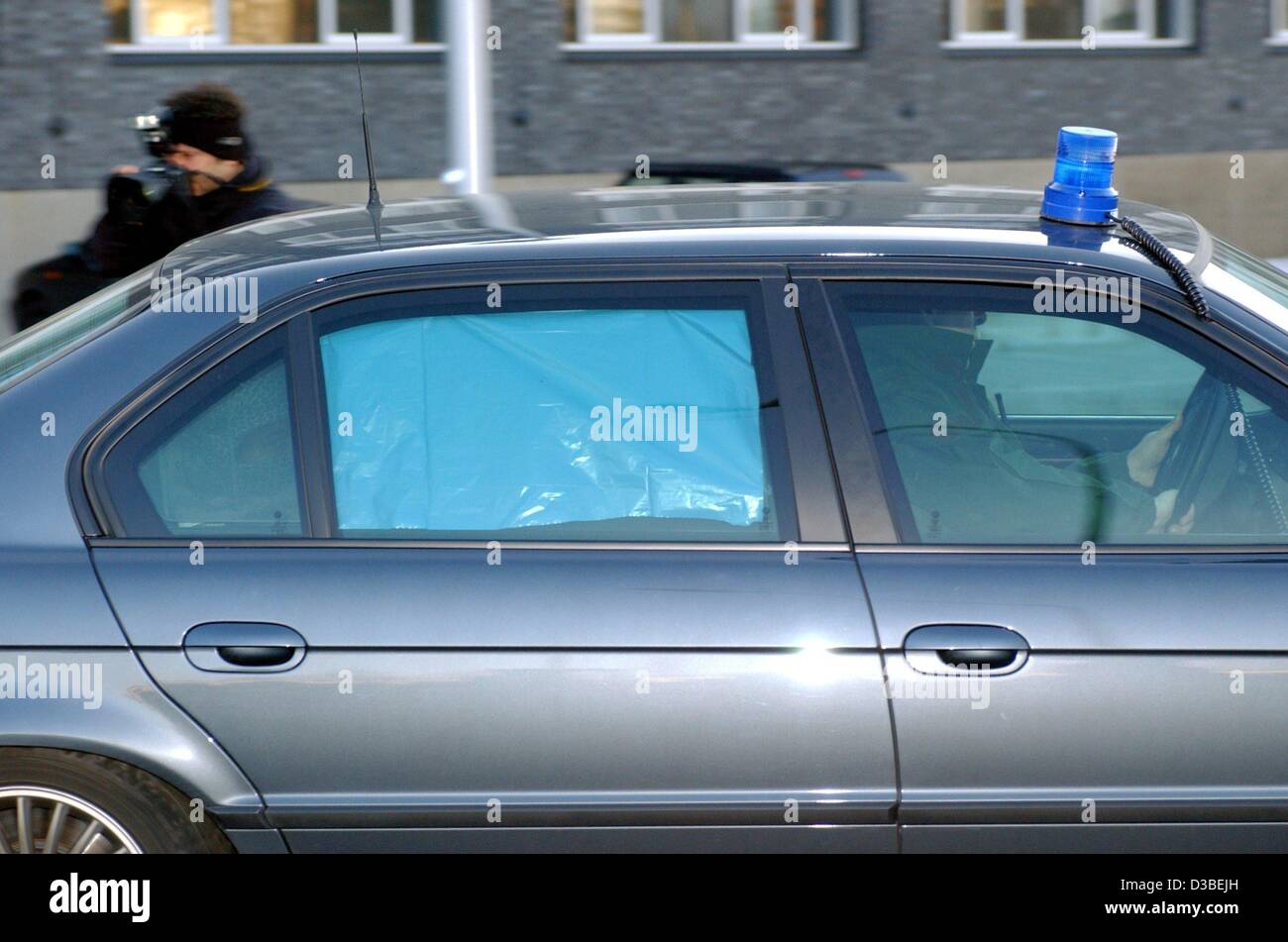 (dpa) - A civilian police car with pasted up windows leaves the police ...