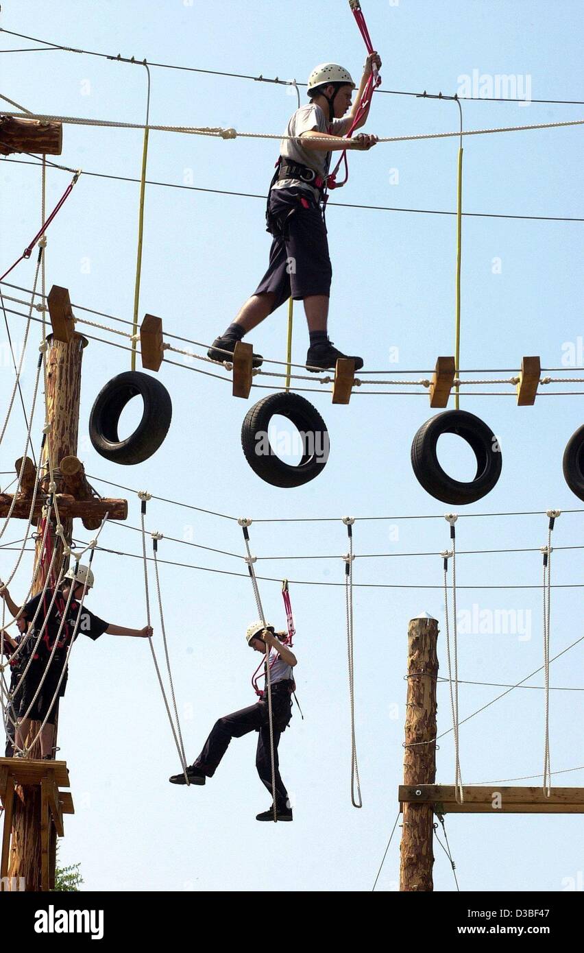 (dpa) - Teenagers climb through a construction of ropes at the ...