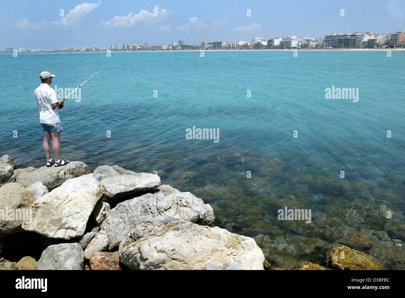 (dpa) - An angler fishes in the blue Mediterranean Sea near El Arenal ...