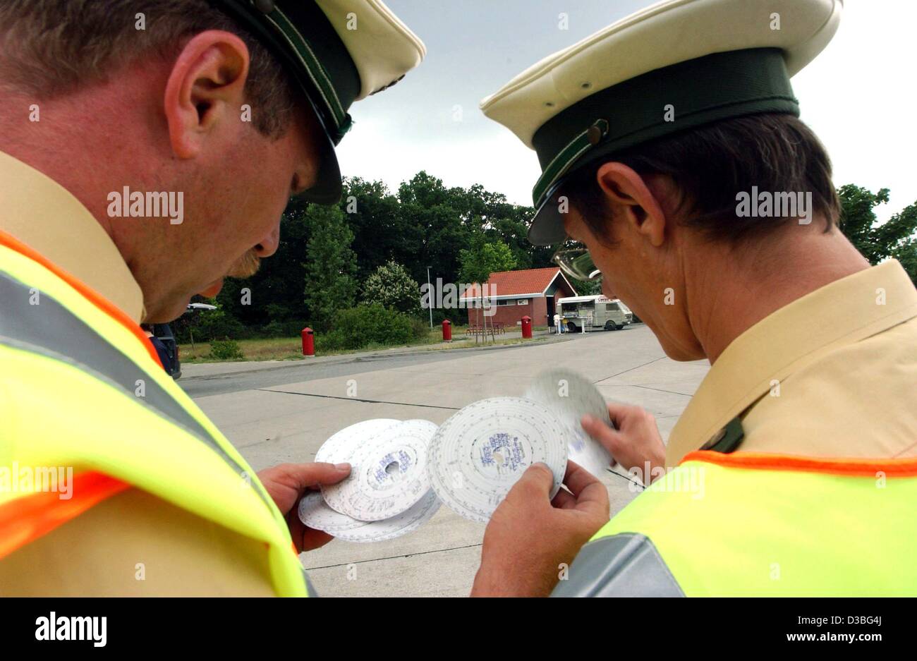 (dpa) - Two officers of the traffic police inspect the tachograph of a ...