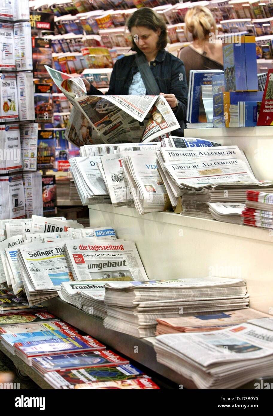 Human interest hum people newspaper reading standing newagent shalfs ...