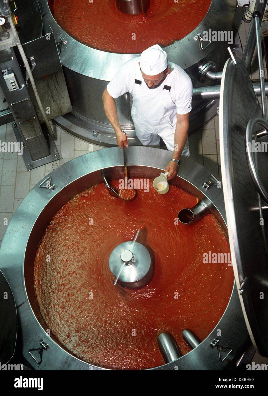 (dpa) - An employee of Maizena is taking a sample from a huge pot of ...