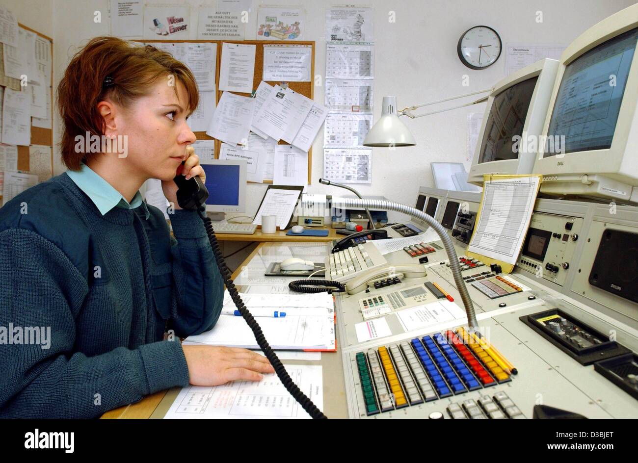 (dpa) - A German customs officer sits in front of panels and computer ...