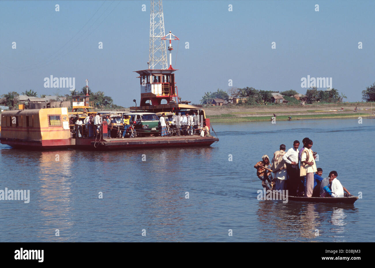 Two ferries crossing the river, a large vehicle carrier and a small ...
