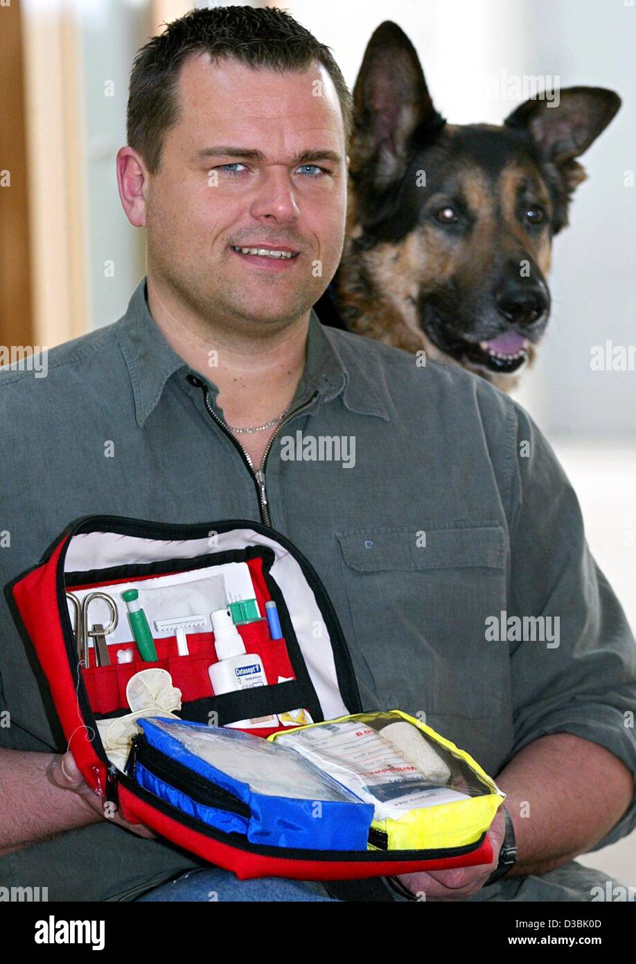 (dpa) - Stephan Schubert and his dog Mac show a first aid kit for dogs ...