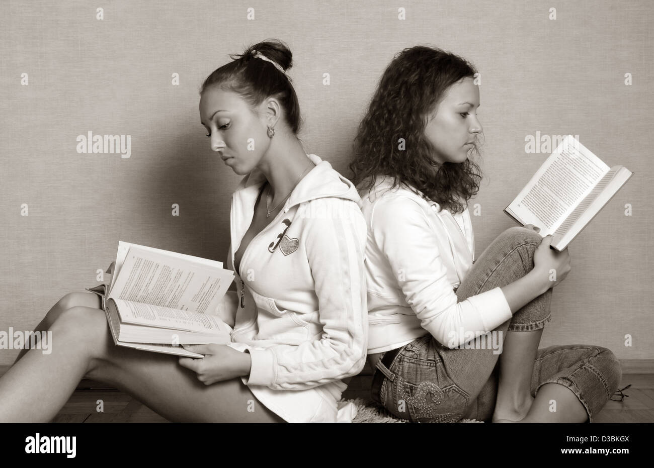 Two young girls of a house with books Stock Photo - Alamy