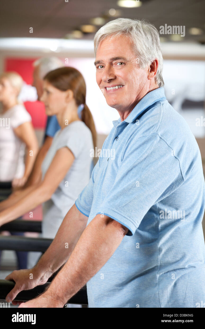 Elderly man exercising on fitness treadmill in gym Stock Photo - Alamy