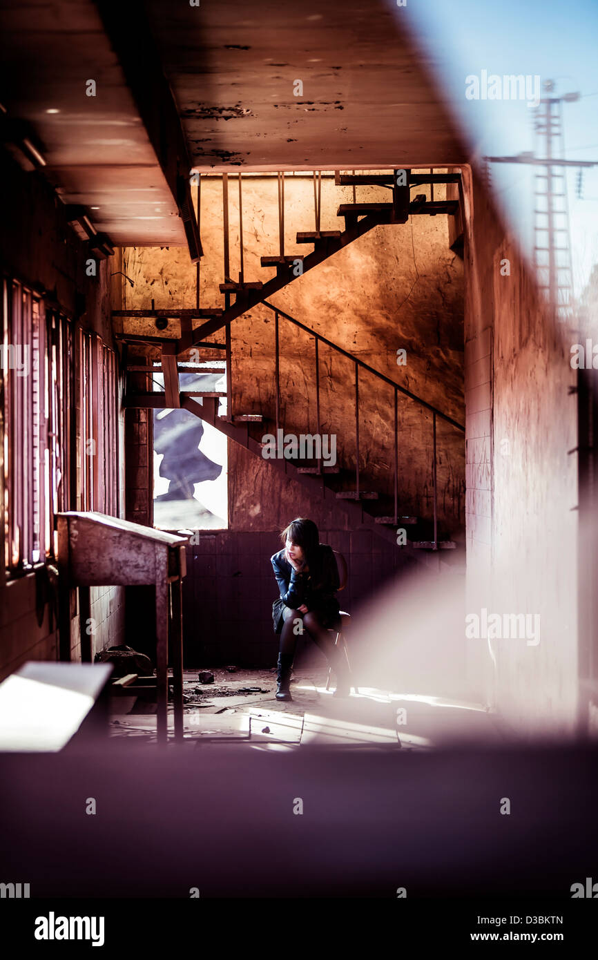 Young beautiful woman inside rusty building Stock Photo - Alamy