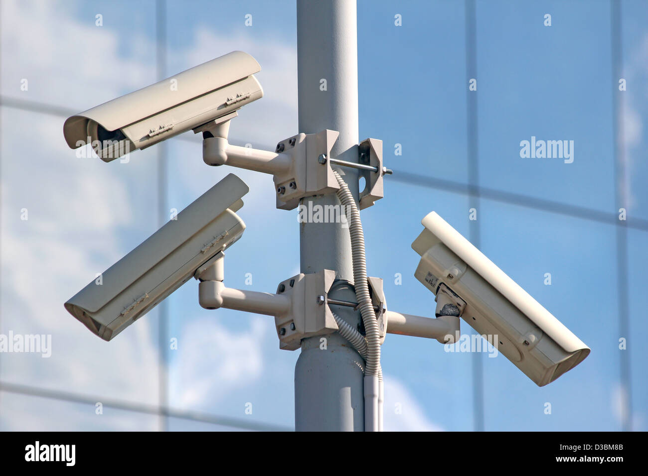 three security cctv cameras on the light pylon Stock Photo - Alamy