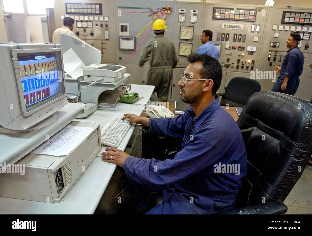 (dpa) - Electrical technicians check the instruments at a power plant ...