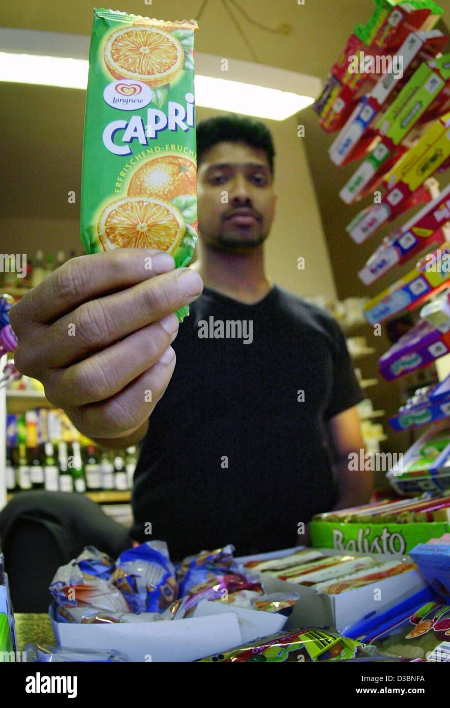 (dpa) - A shop assistant holds a Capri water ice with orange flavour ...