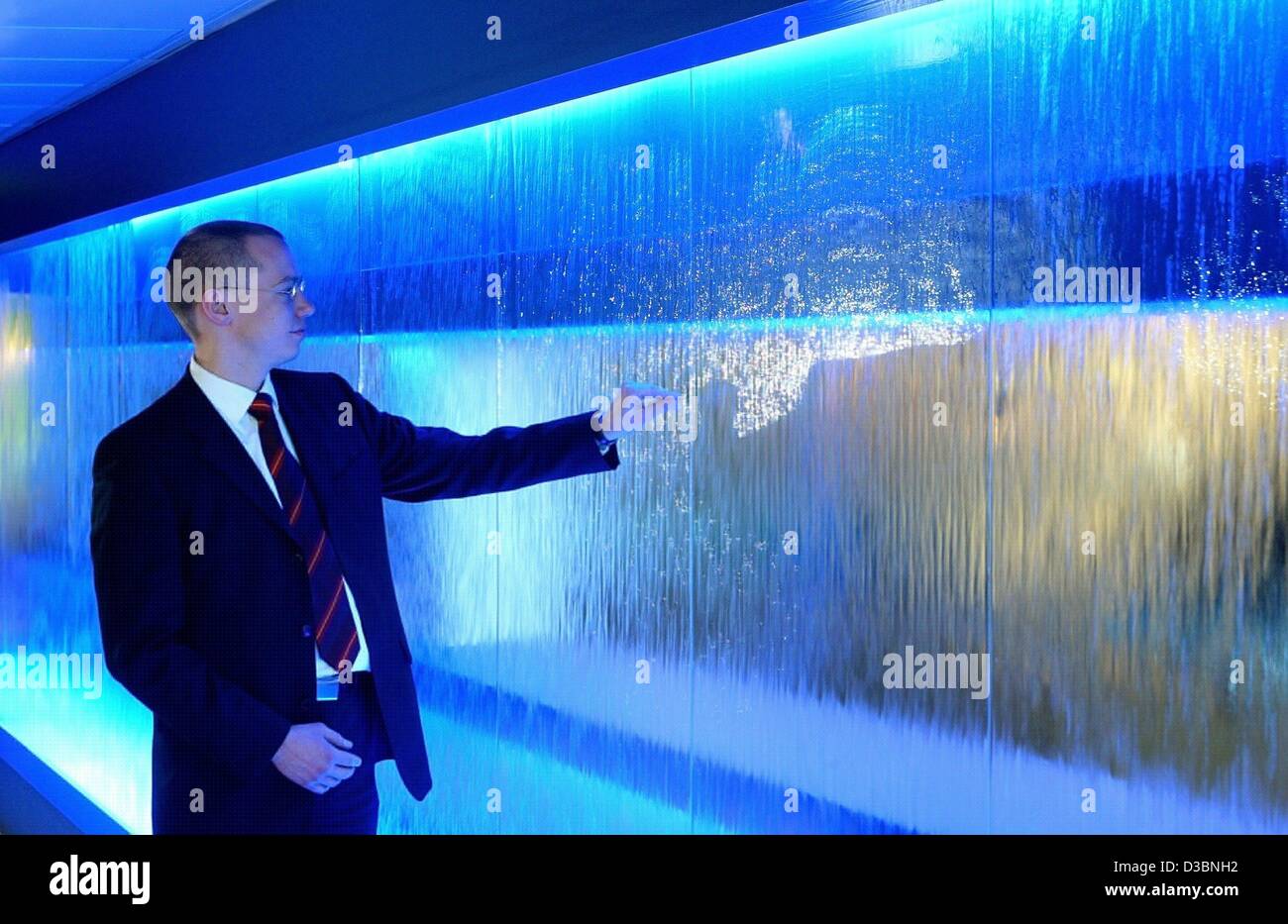 (dpa) - A glass wall is dipped into blue light at the market stand of ...