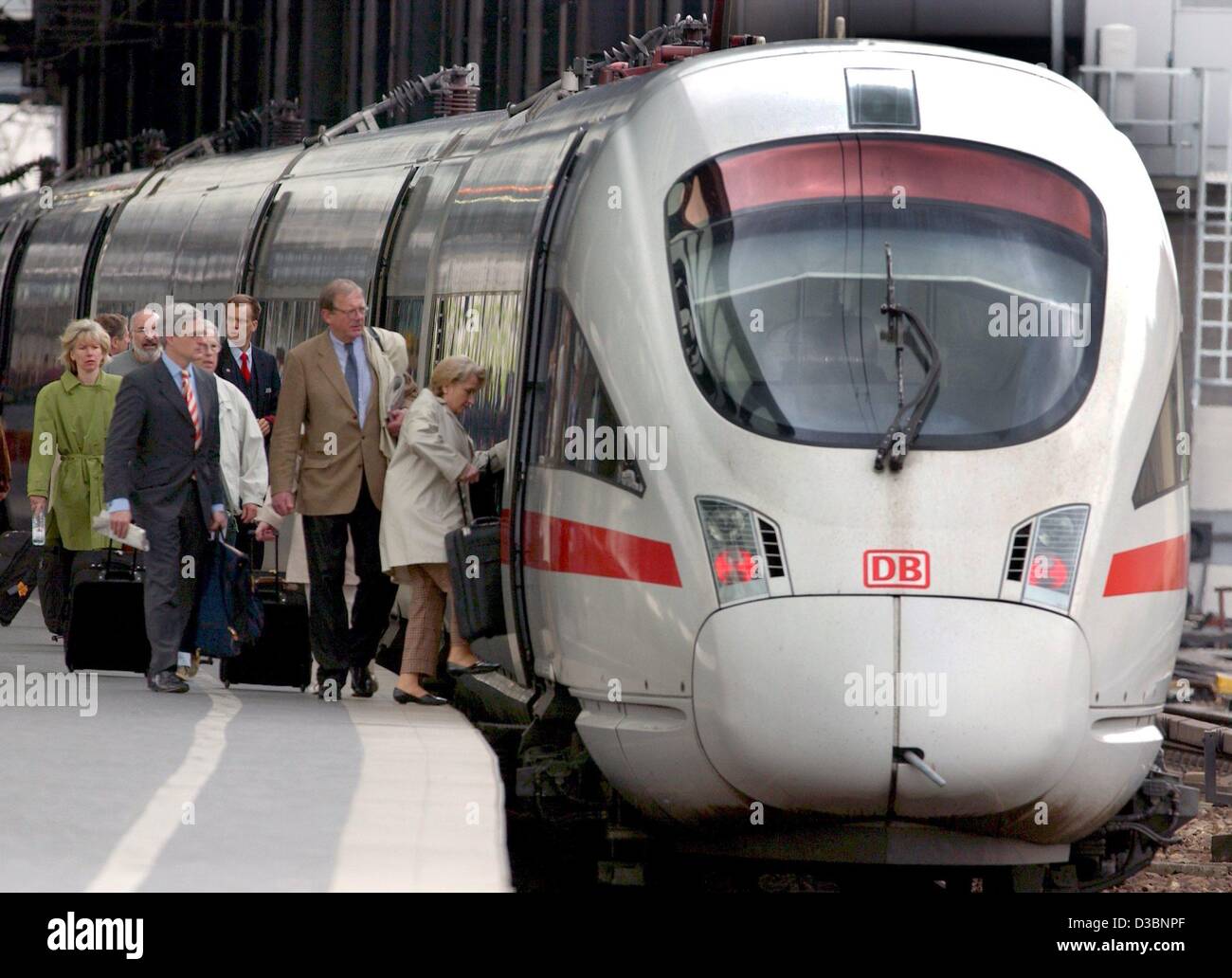 (dpa) - Travellers board an ICE (Inter City Express) high speed train ...