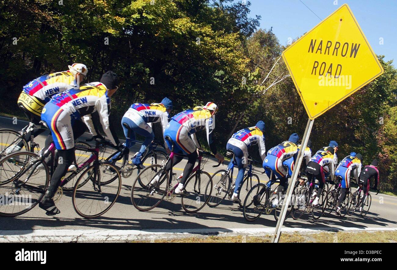 (dpa) - The cyclists of the German national team race past a road sign ...