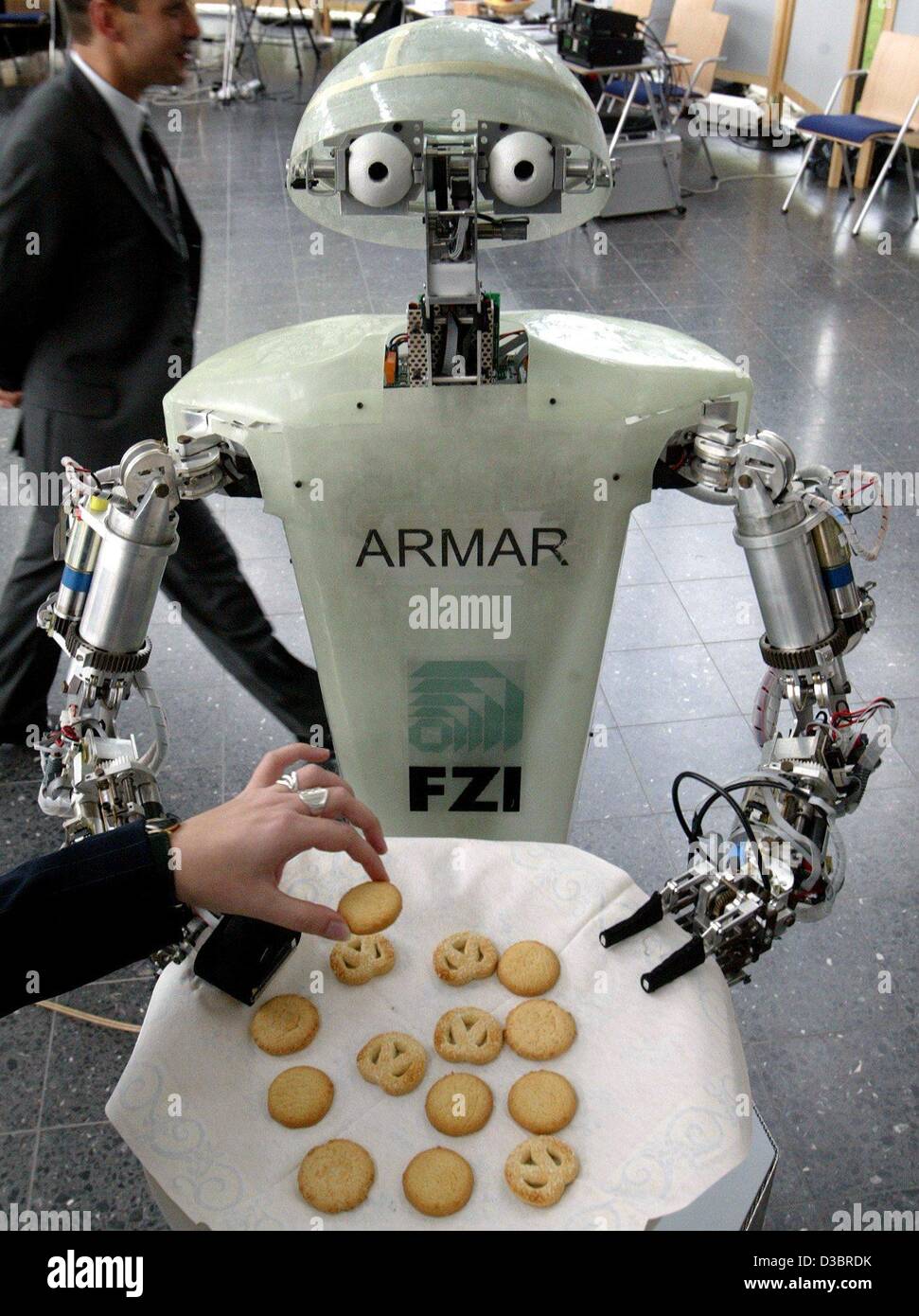 (dpa) - Armar the robot serves cookies and biscuits from a tray at the ...