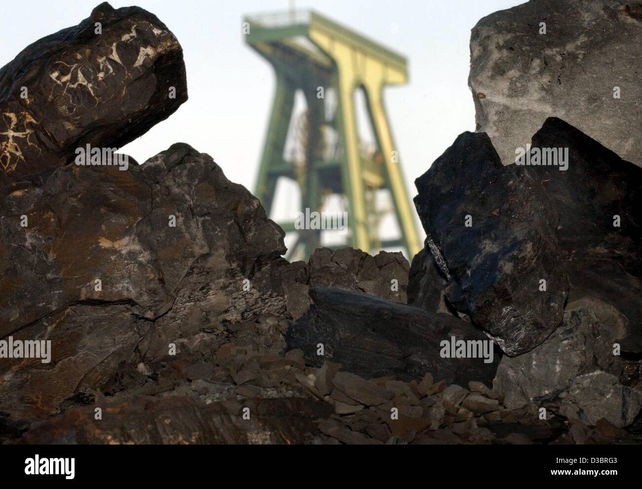 (dpa) - A view past a pile of coal (front) towards the winding tower ...