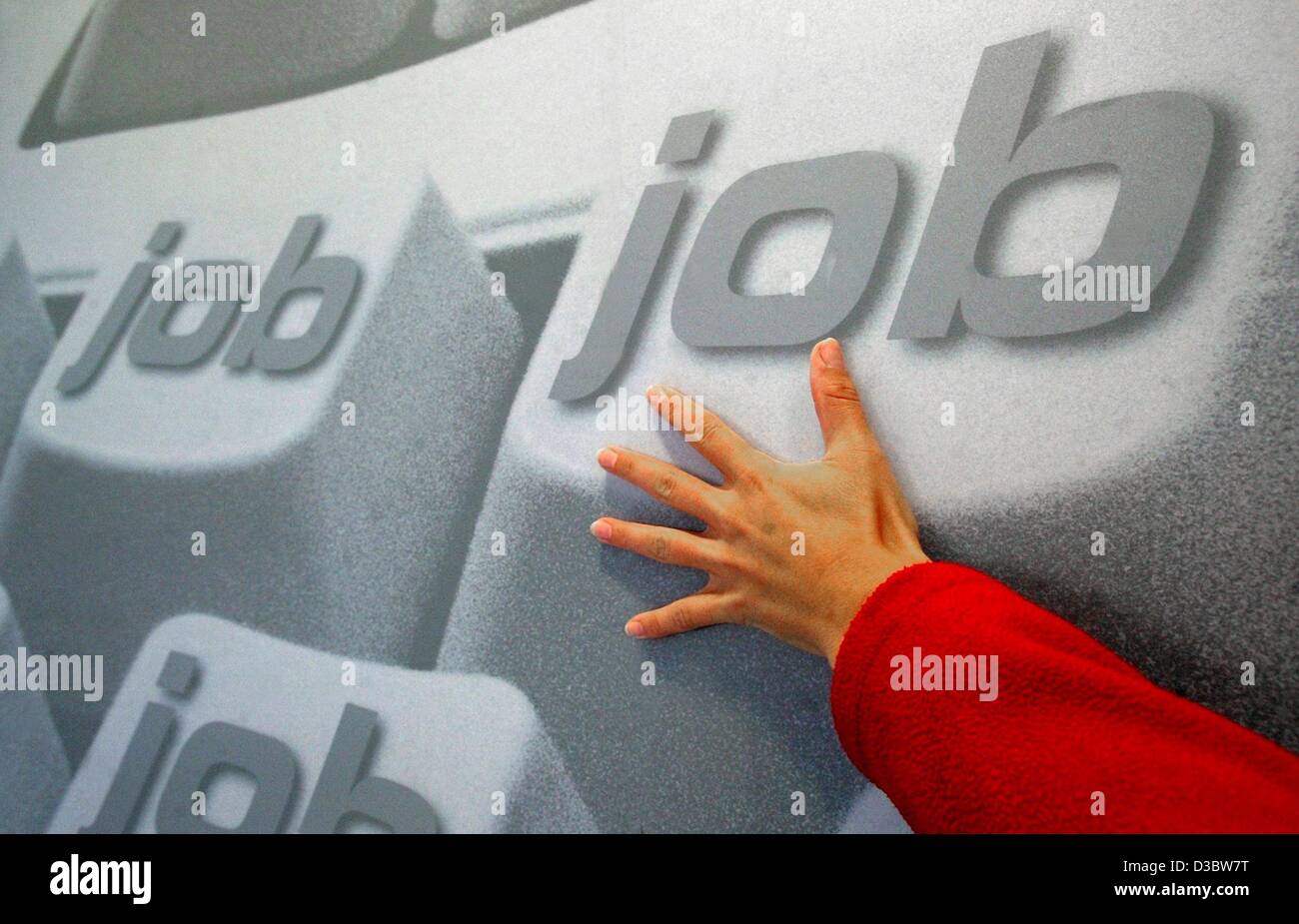 (dpa) - A hand touches a poster with an oversize computer keyboard ...