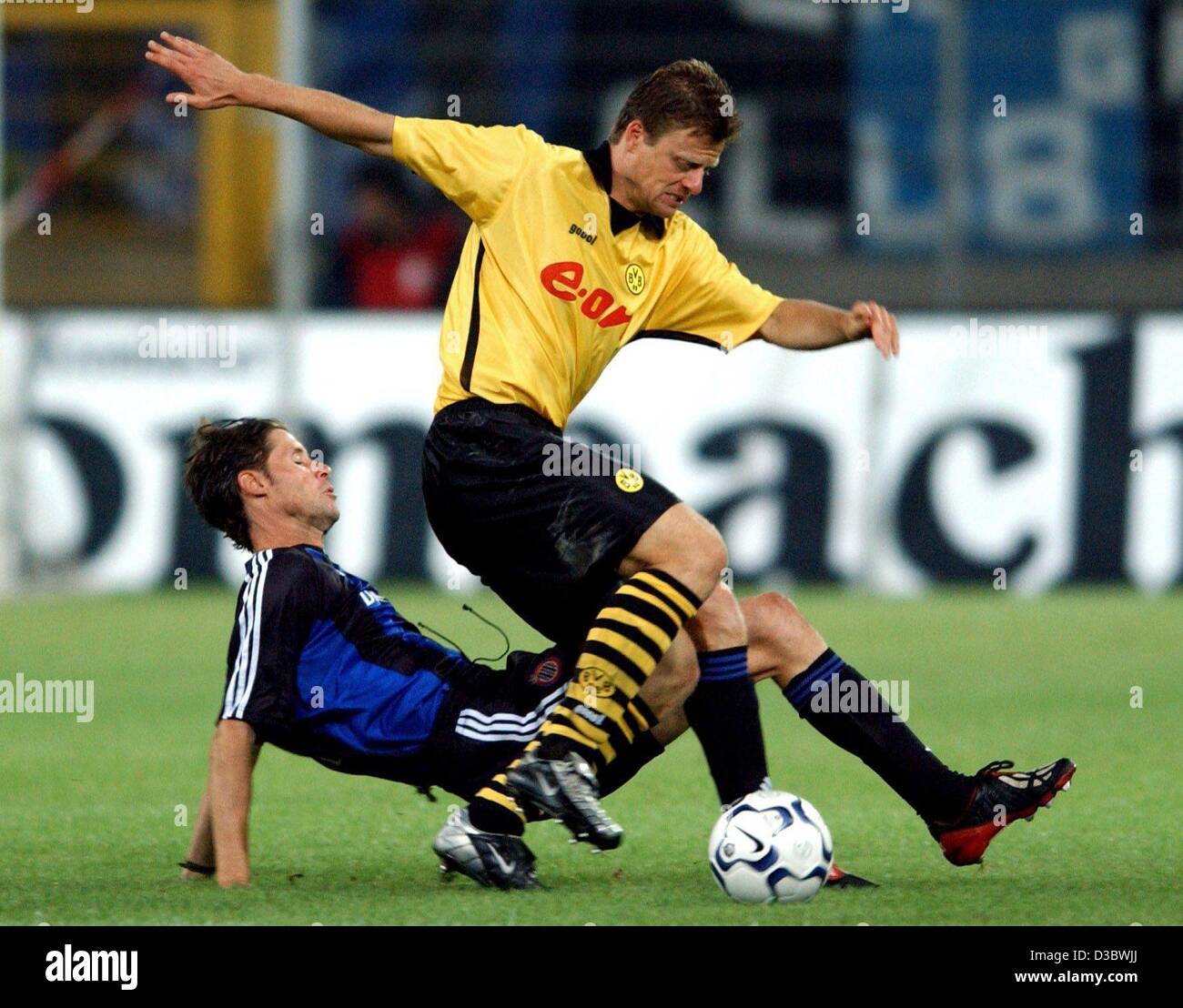 (dpa) - Dortmund's defender Christian Woerns (yellow tricot) in a duel ...