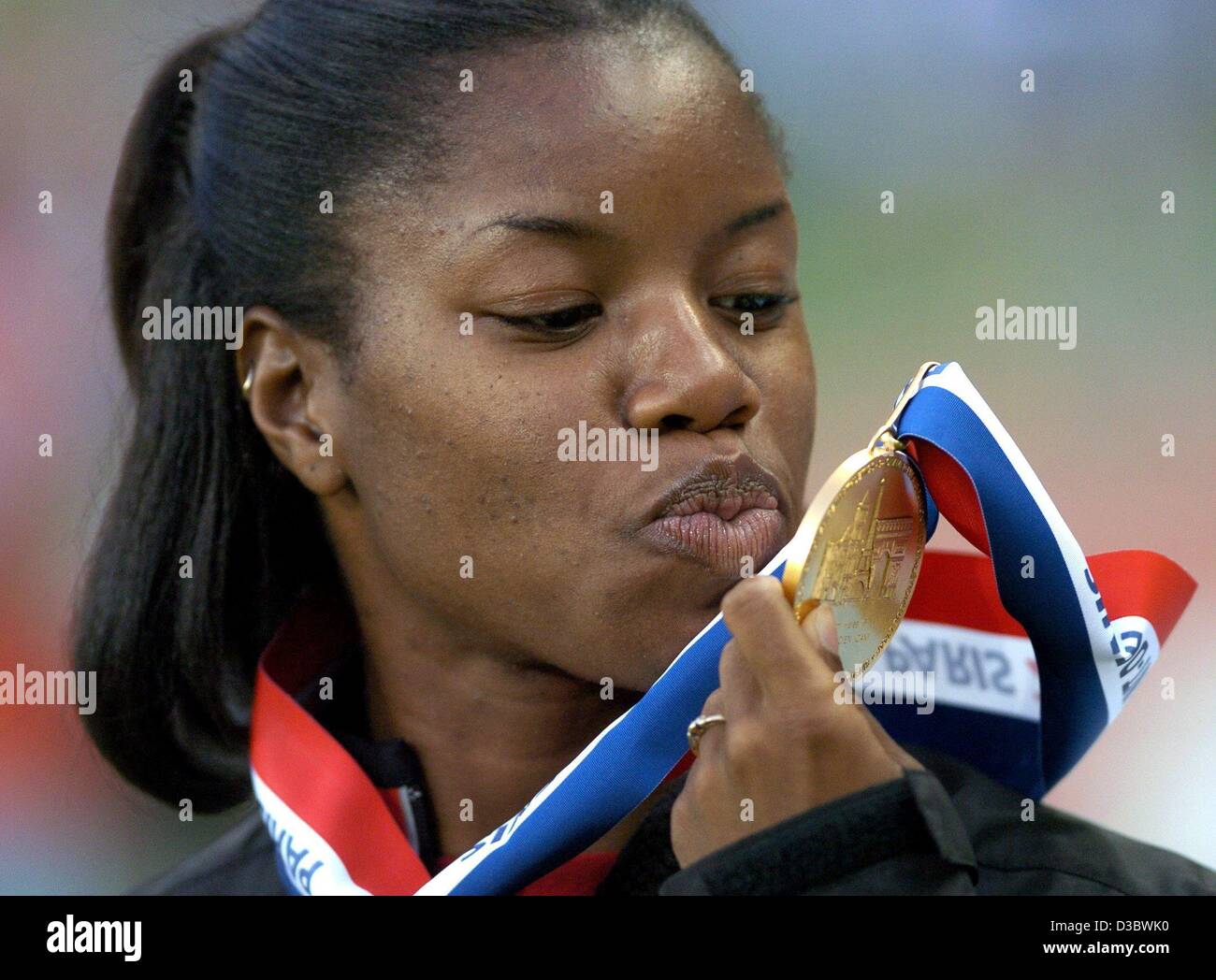 (dpa) - Canadian Perdita Felicien looks at the gold medal she won at ...
