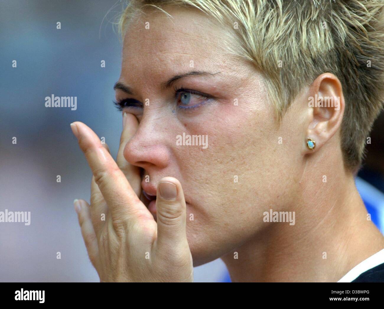 (dpa) - German shot putter Astrid Kumbernuss wipes away a tear after ...