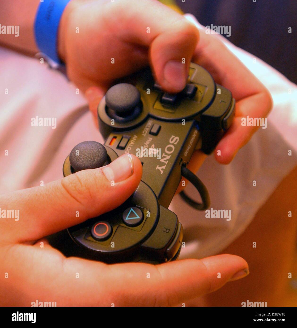 (dpa) - A visitor plays a computer game with a remote control at the ...