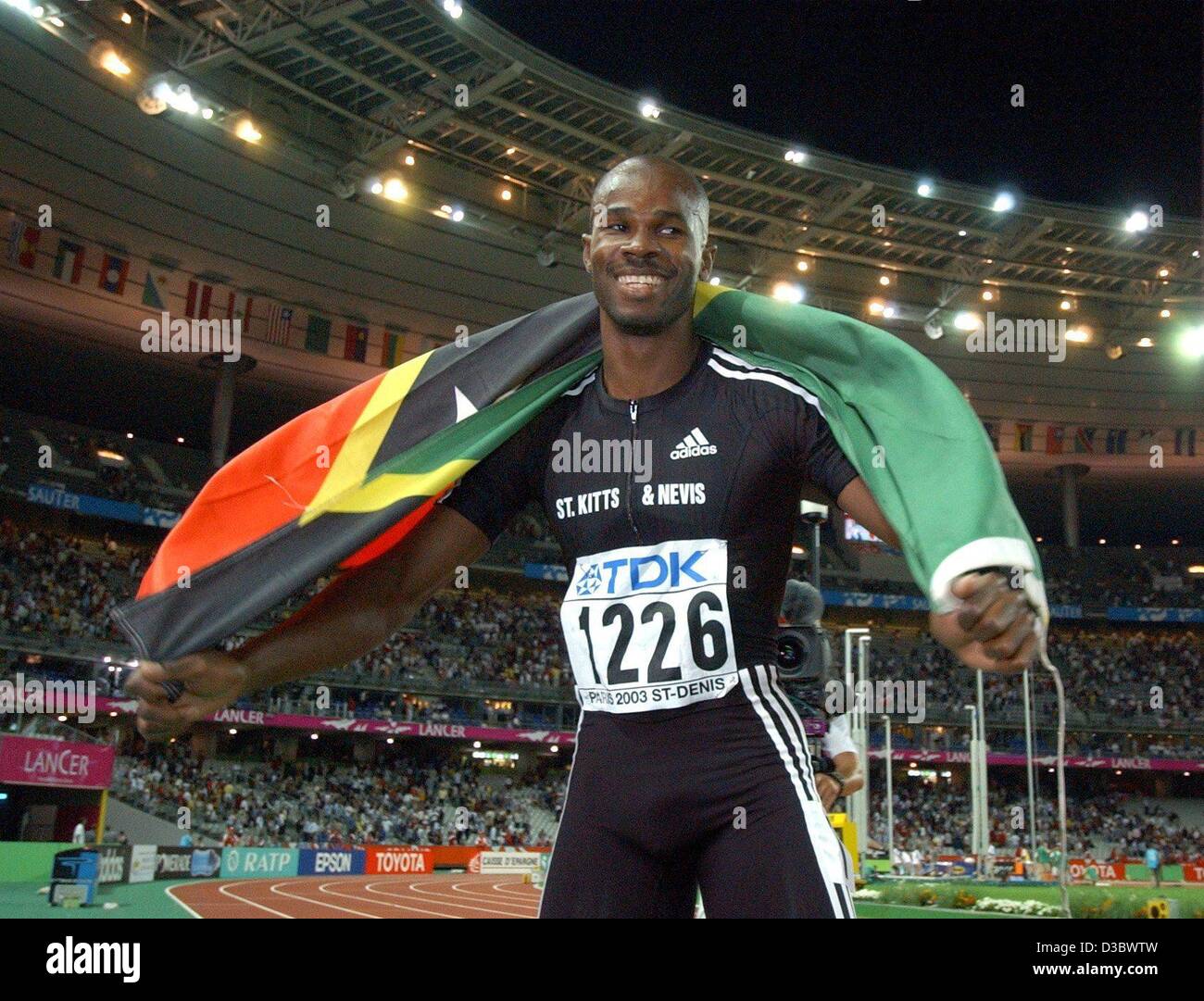 (dpa) - The sprinter Kim Collins from St. Kitts and Nevis holds up his ...