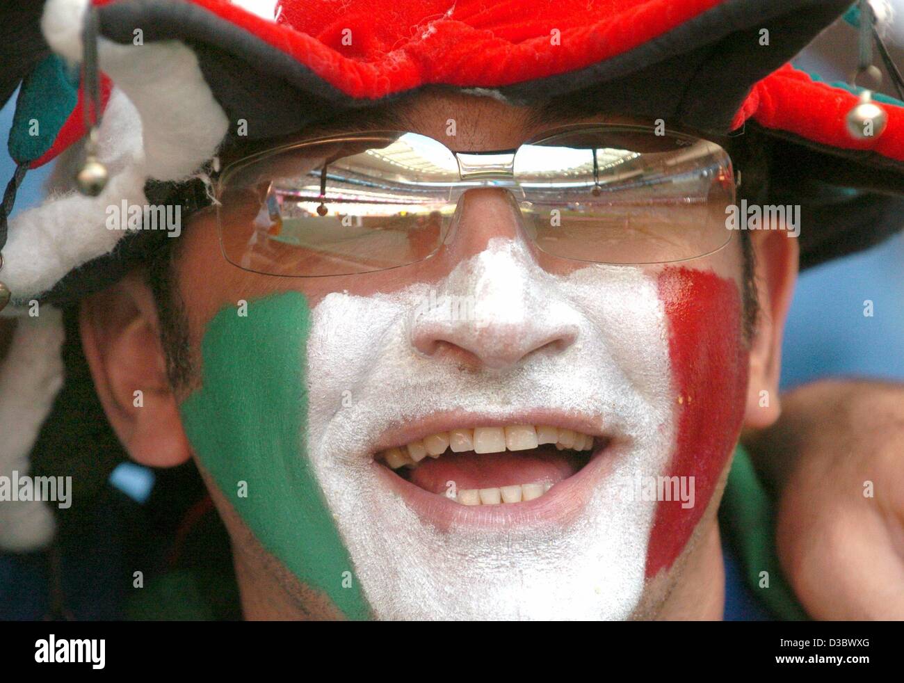 (dpa) - An Italian fan has painted his face in his country's colours as ...