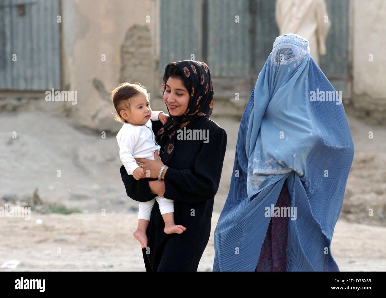 (dpa) - Two women, one of them wearing the traditional blue burka veil ...