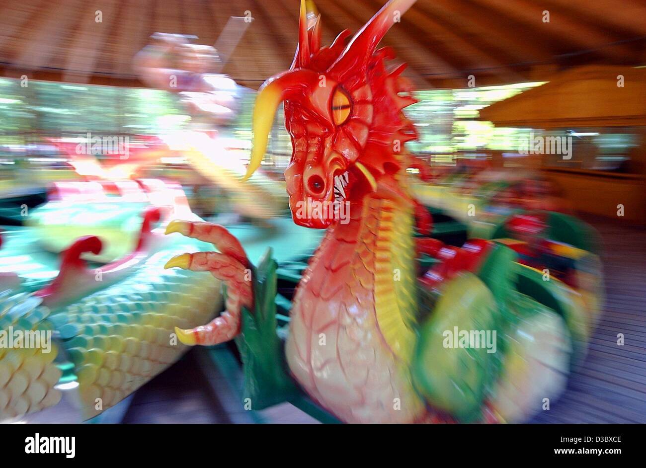 (dpa) - A dragon merry-go-round swings around in circles at a theme ...
