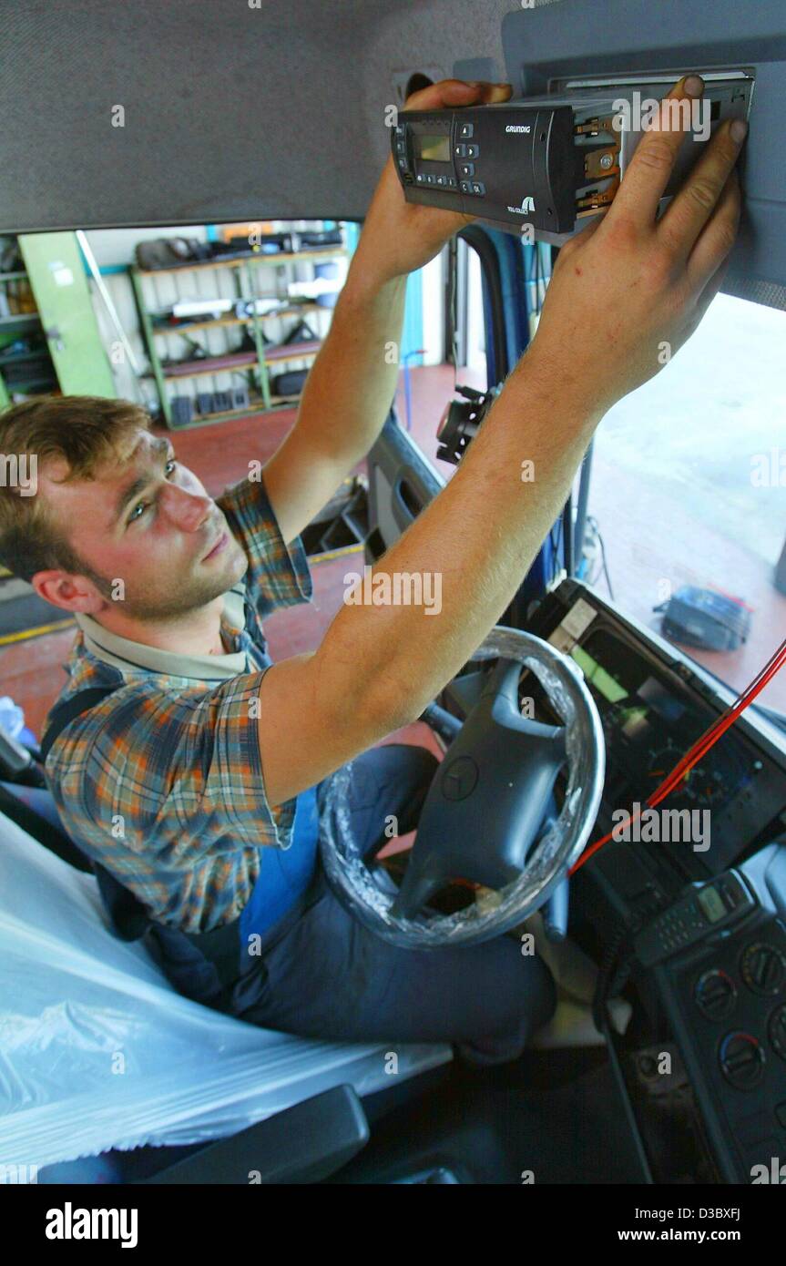 (dpa) - Mechanic Stefan Tasche sits in the driver's cabine and installs ...