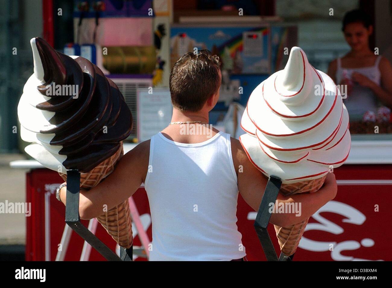 (dpa) - An iceman carries two huge ice cream decorations to his stand ...