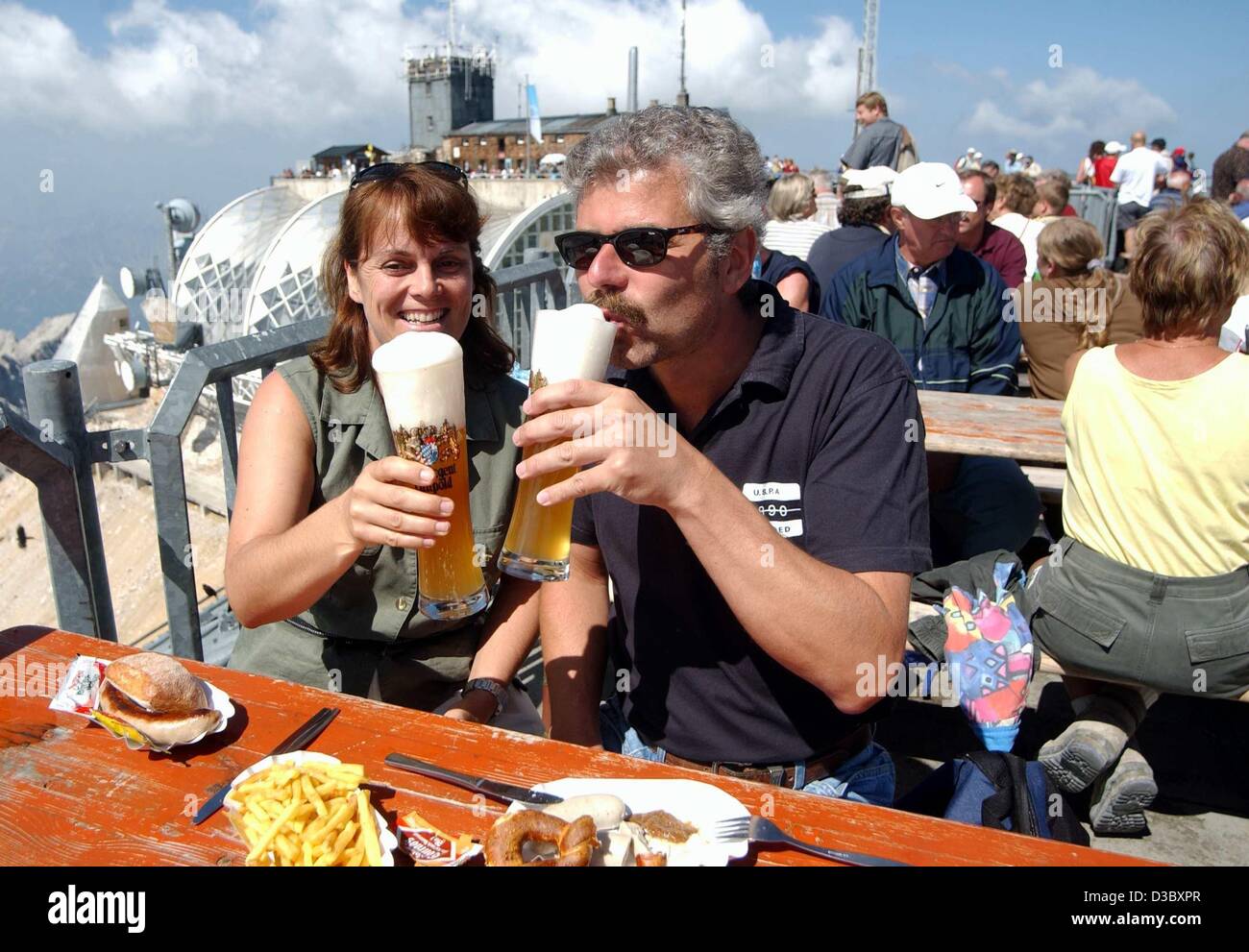 (dpa) - Hikers have a beer on the top of the Zugspitze Mountain in ...