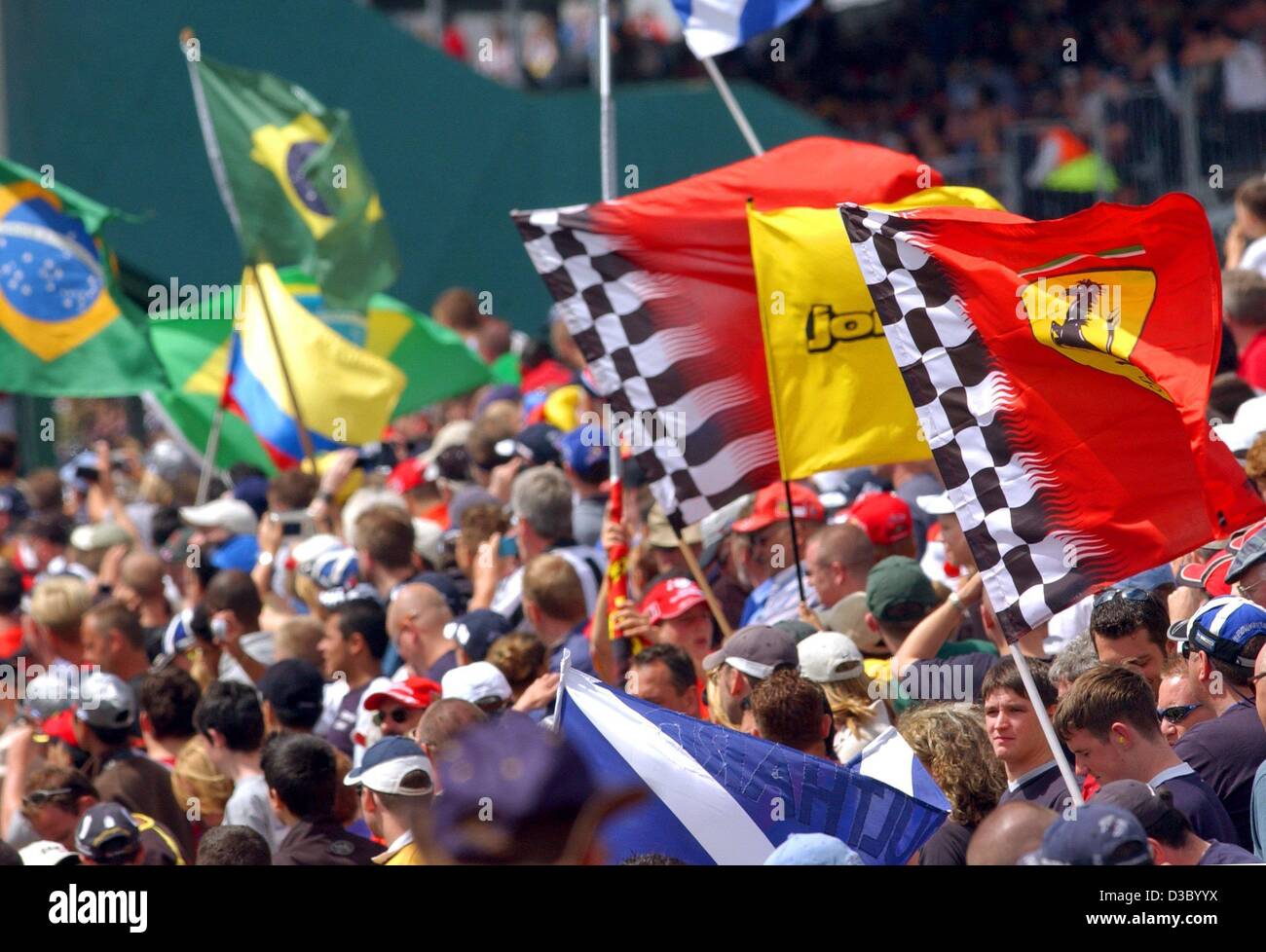 (dpa) - A crowd of cheering formula one fans wave flags with the logo ...