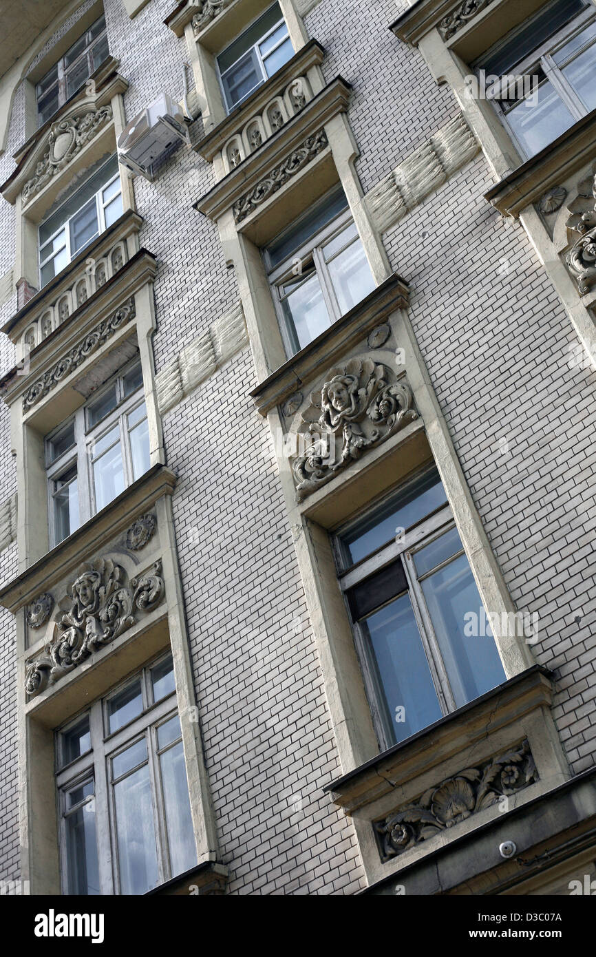 A strip of windows and a wall with bas-reliefs Stock Photo - Alamy