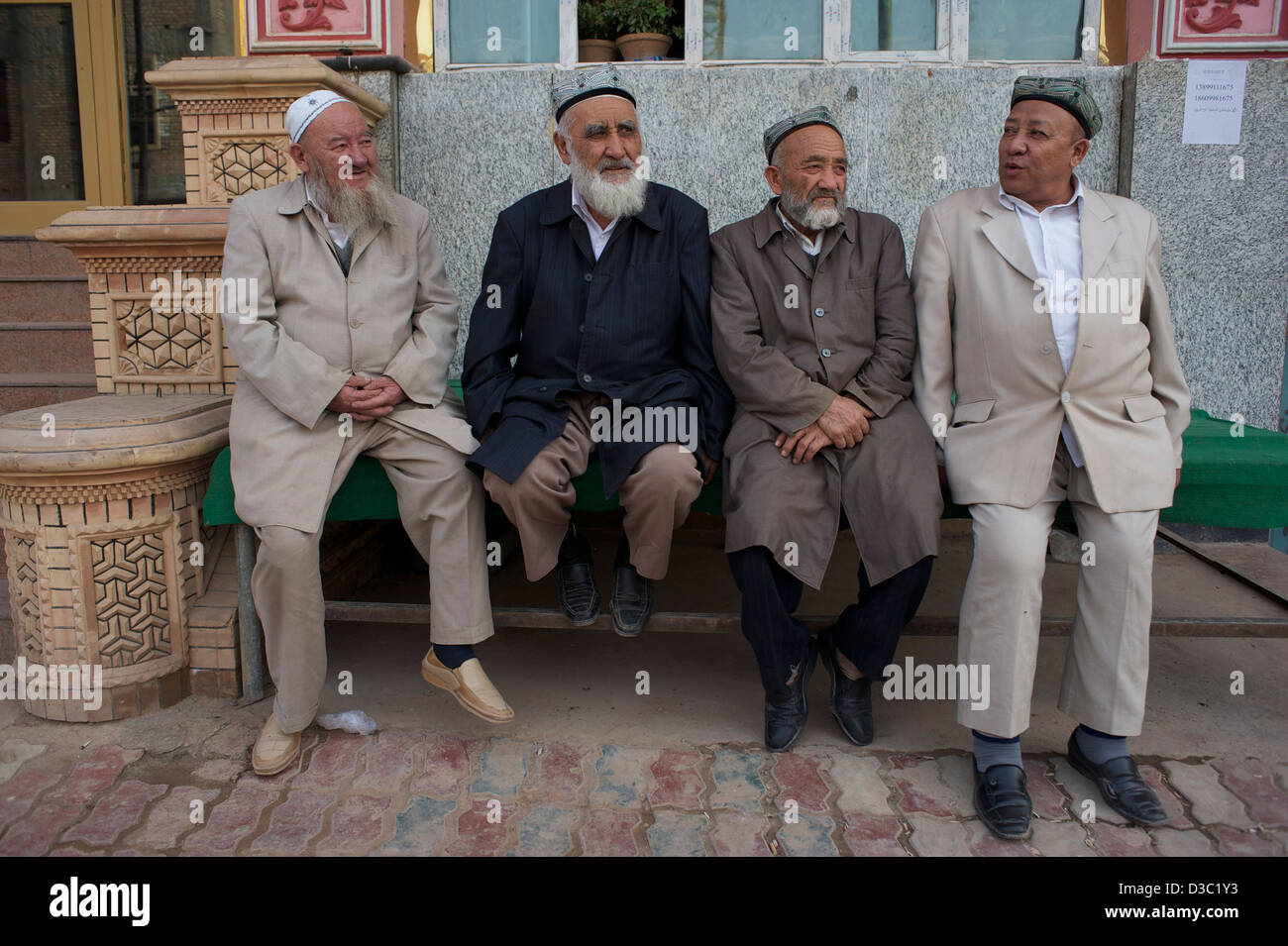 4 men sitting Stock Photo - Alamy