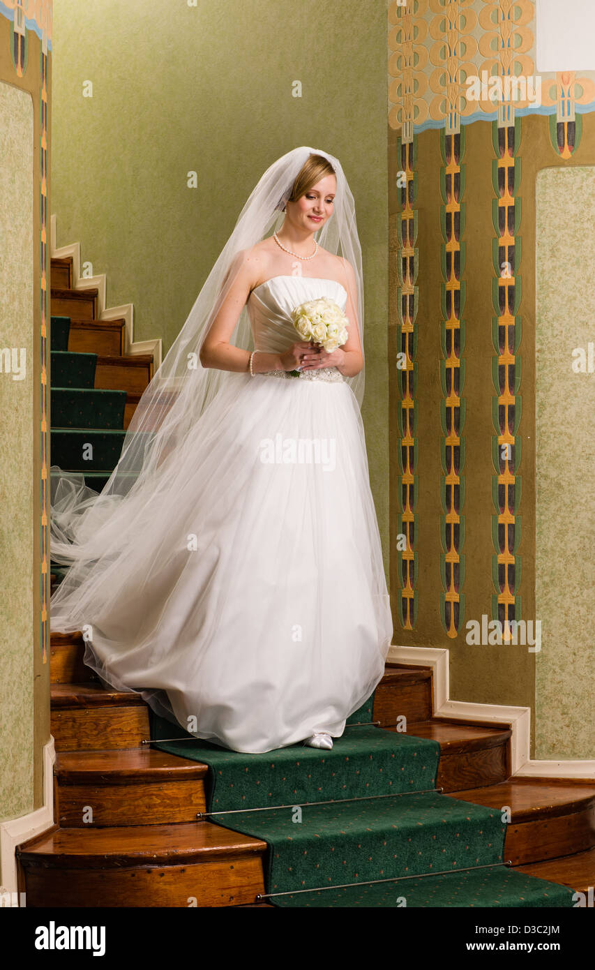 Beautiful bride is walking on the stairs Stock Photo - Alamy