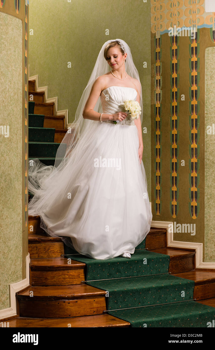 Beautiful bride is walking on the stairs Stock Photo - Alamy