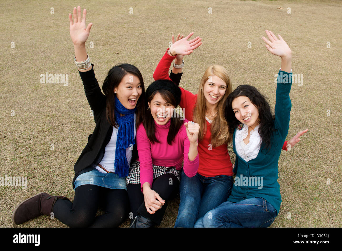 Group of 4 college students outdoor cheering Stock Photo - Alamy