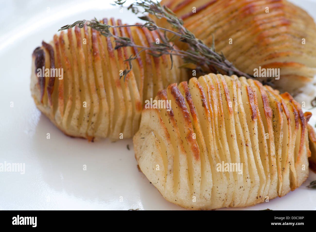Hasselback Swedish potatoes with Sour Cream Stock Photo - Alamy