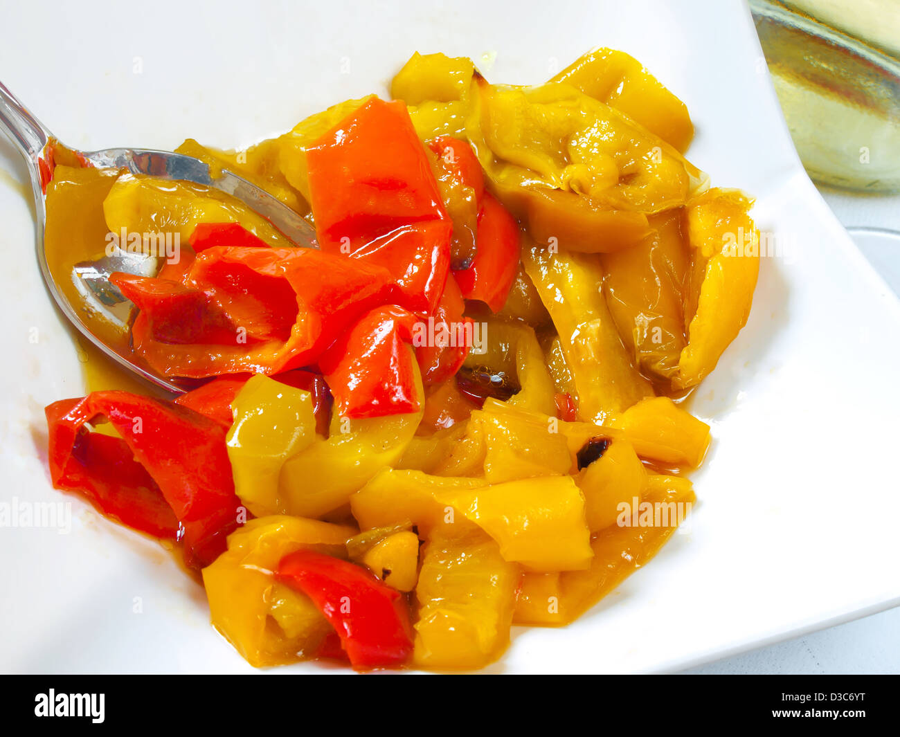 bowl of peppers fried in olive oil Stock Photo - Alamy