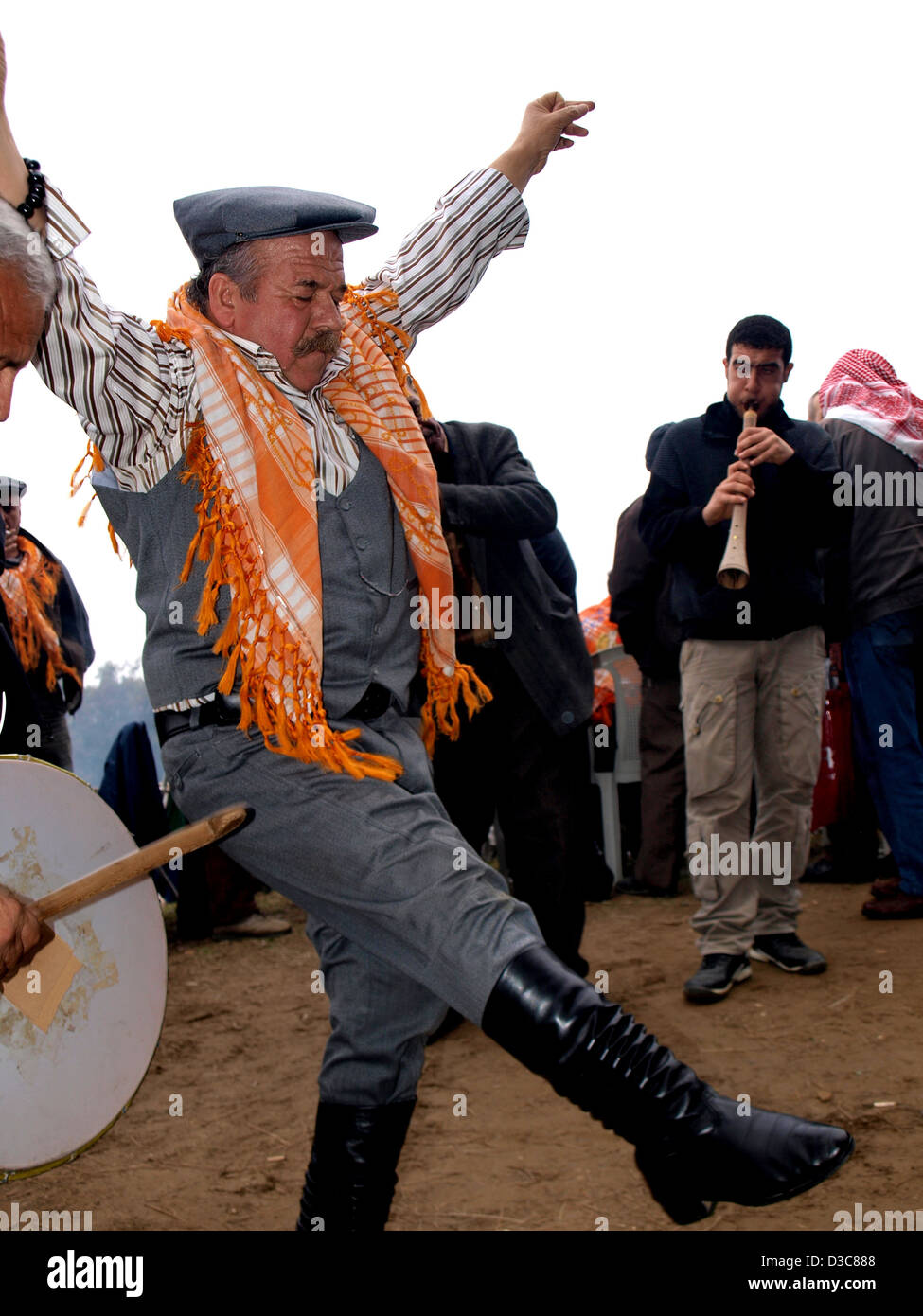Man dancing Zeybek dance while musicians play during Selcuk-Efes Camel ...