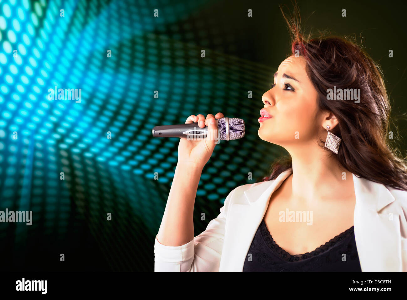 Teenage girl singing into microphone Stock Photo - Alamy