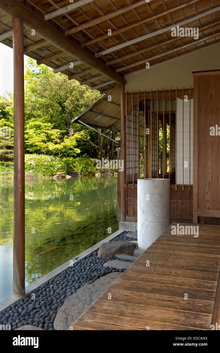 Garden views and koi swimming in pond off veranda deck of the ...